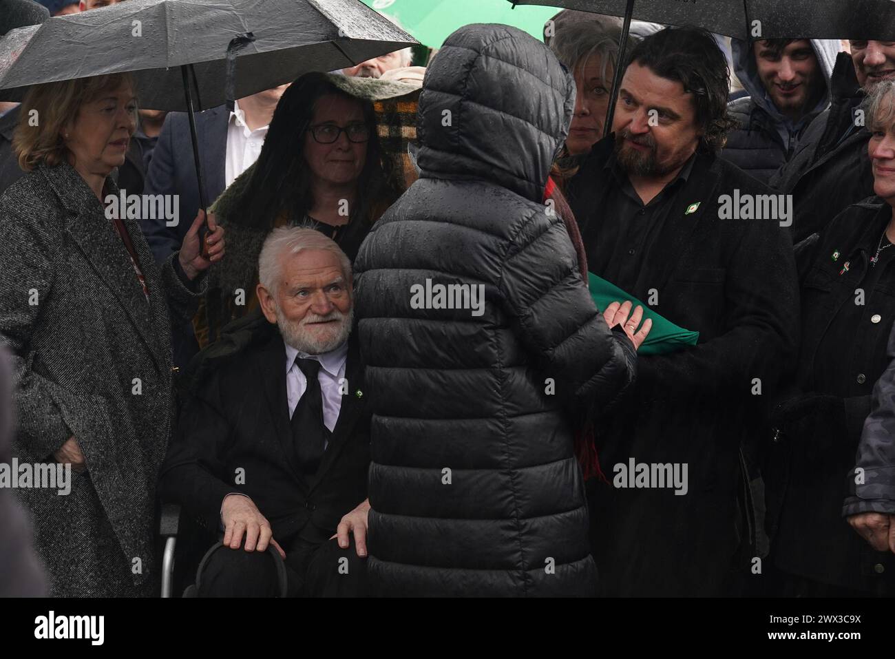 Marion Coyle, hands the folded tricolour removed from the casket of ...