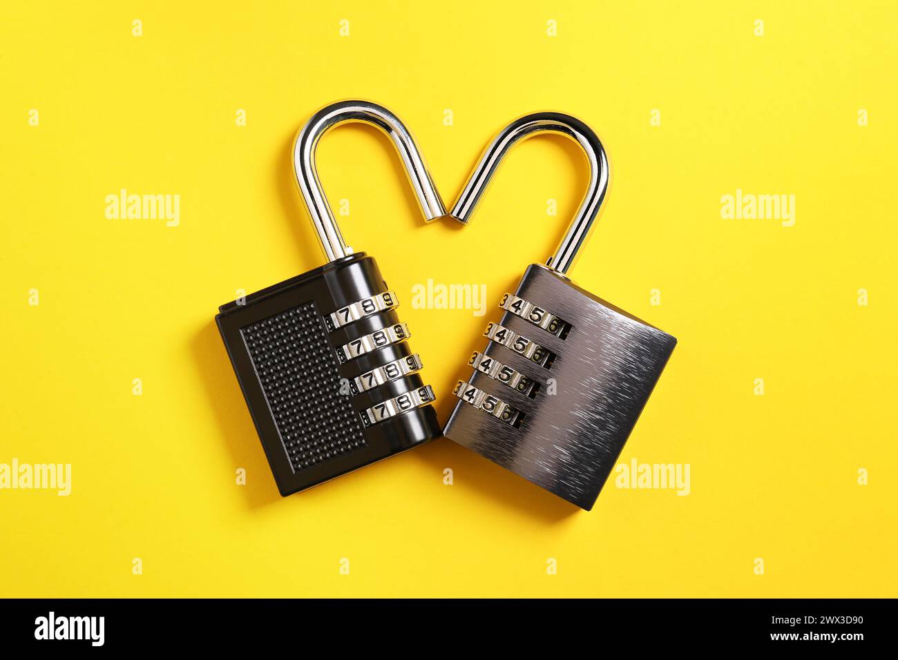 Steel combination padlocks on yellow background, top view Stock Photo ...