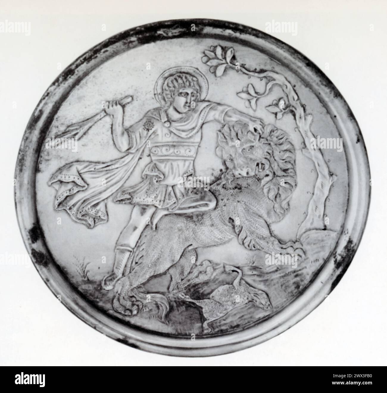 a silver plate depicting the biblical scene of David slaying the lion ...