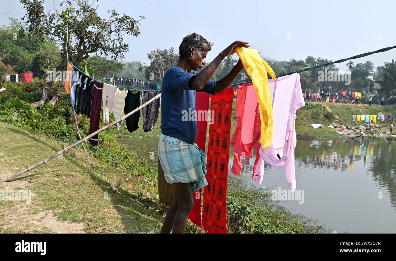Man washing clothes in pond hi-res stock photography and images - Alamy