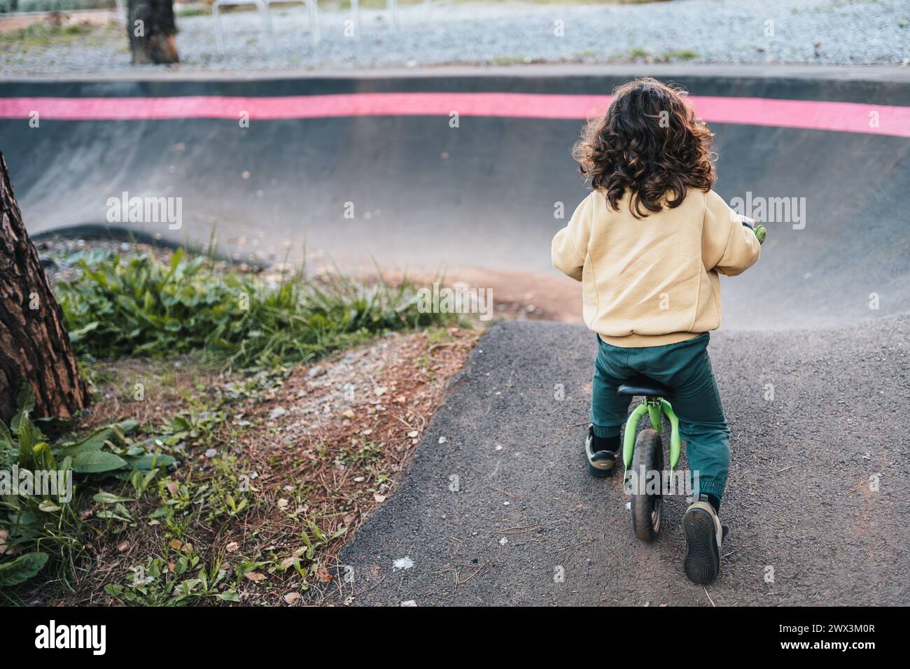 happy fashionable little boy training on pump track circuit Stock Photo ...
