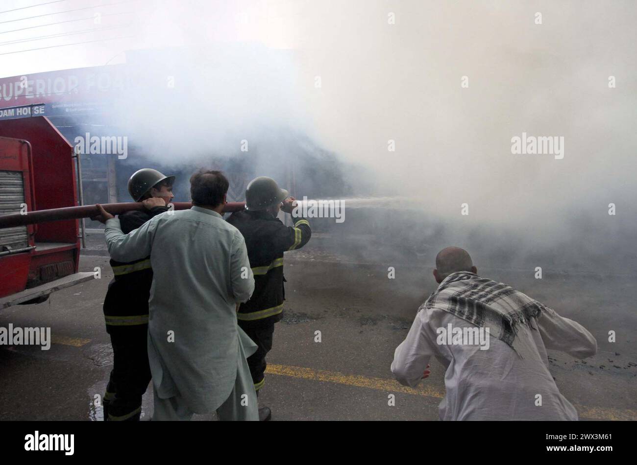 Smoke rising after cylinder explosion as the fire brigade staff are ...