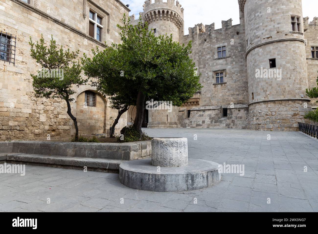 Knight hospitaller palace square with stone paving, towers, and small ...