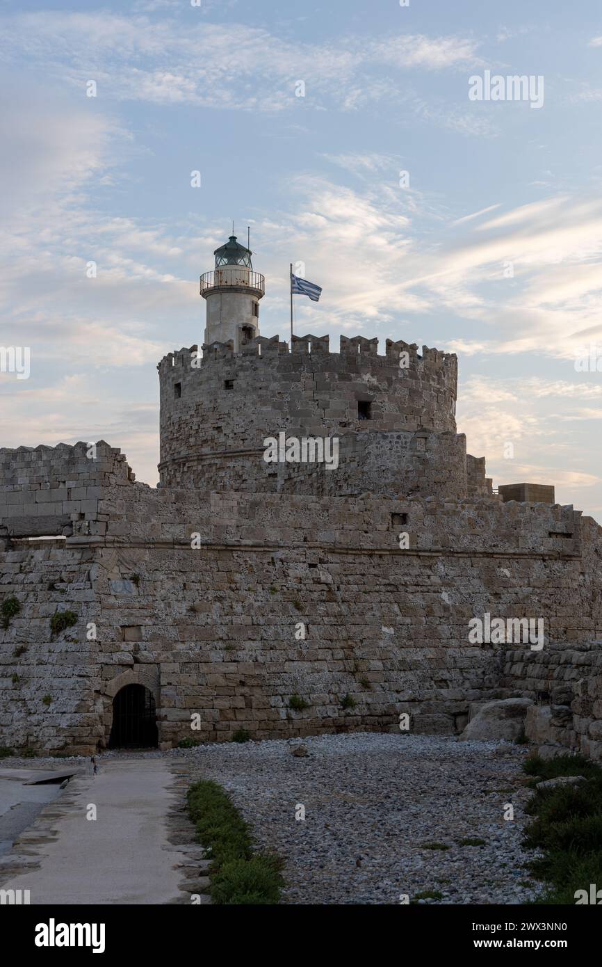 Medieval stone structure and lighthouse in old harbor of Rhodes, Greece ...