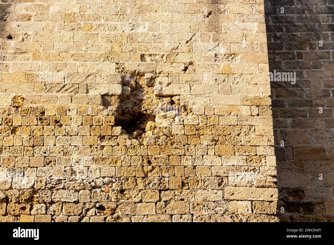 War damage in stone wall in the moat of old town Rhodes, Geece Stock ...