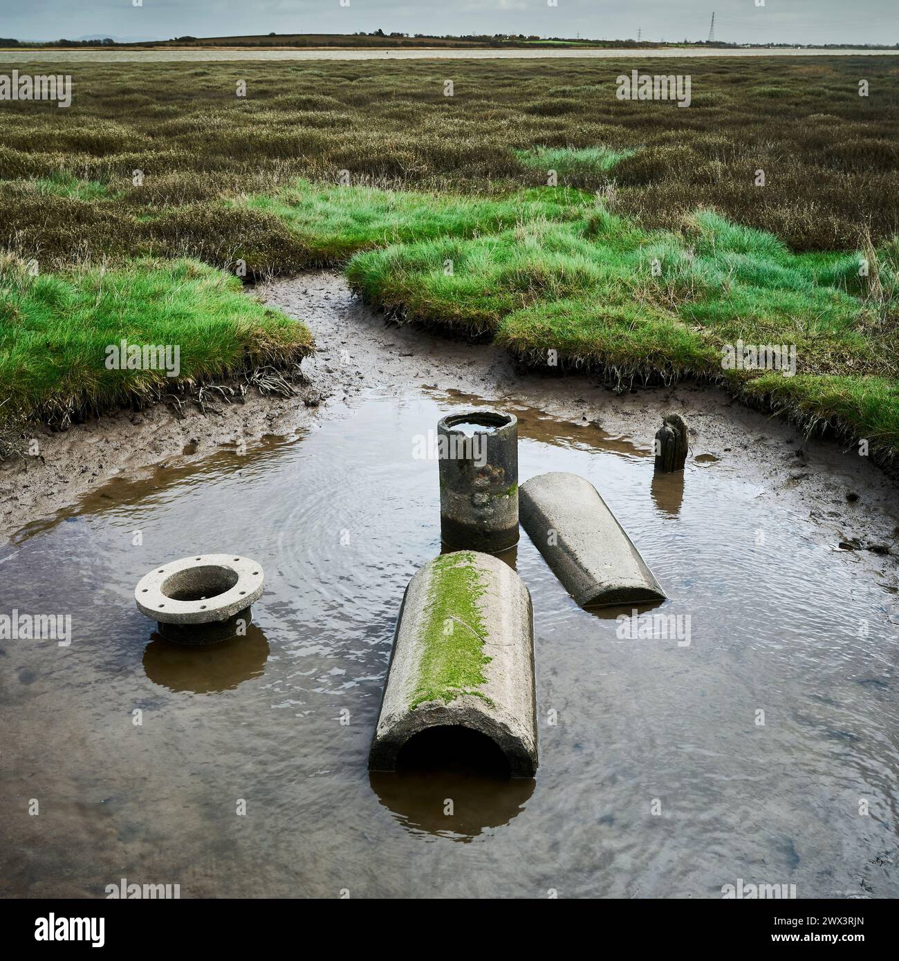 Cylindrical concrete objects in pool of water on river estuary Stock ...