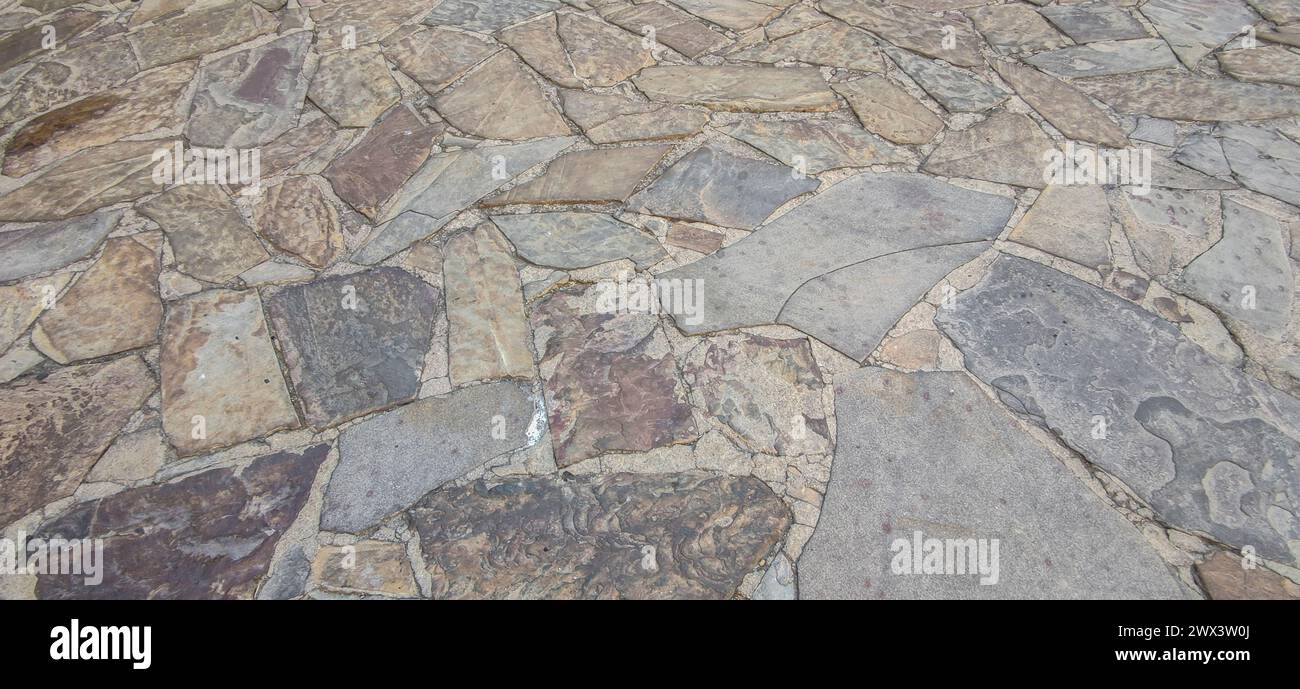 Cobblestone pavement made with quartzite undevastated slabs. Monumental ...