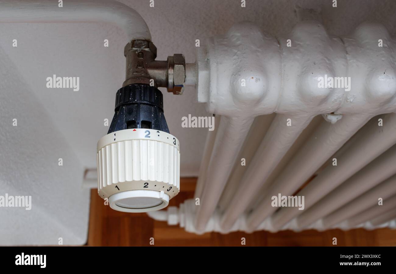 Typical old heading radiator with radiator adjustment knob Stock Photo ...