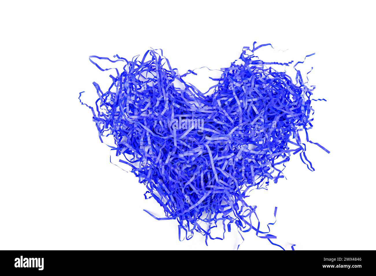 shredded paper in the shape of a heart on a white background. A heart ...
