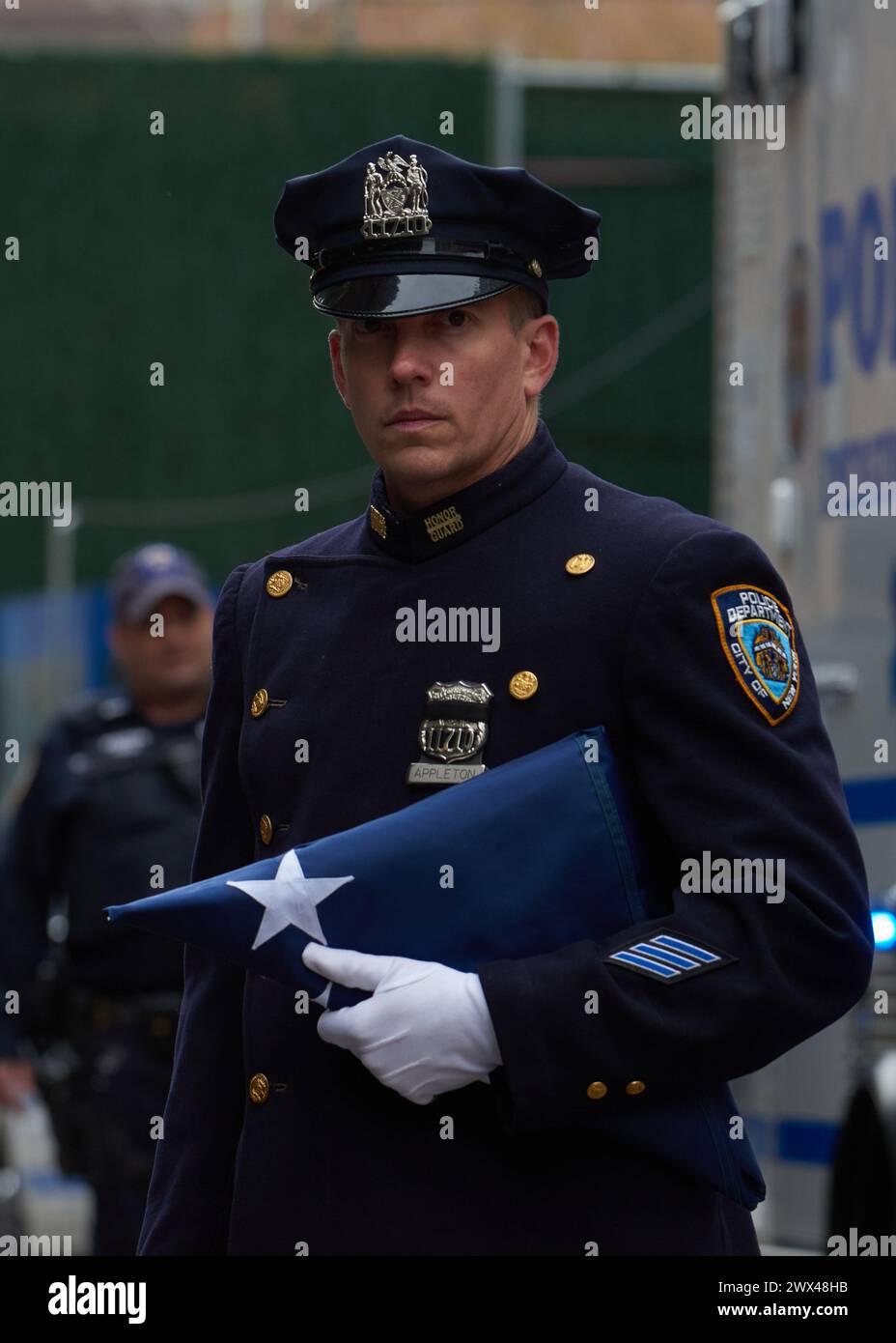 New York, New York, USA. 26th Mar, 2024. NYPD officer carries folded ...