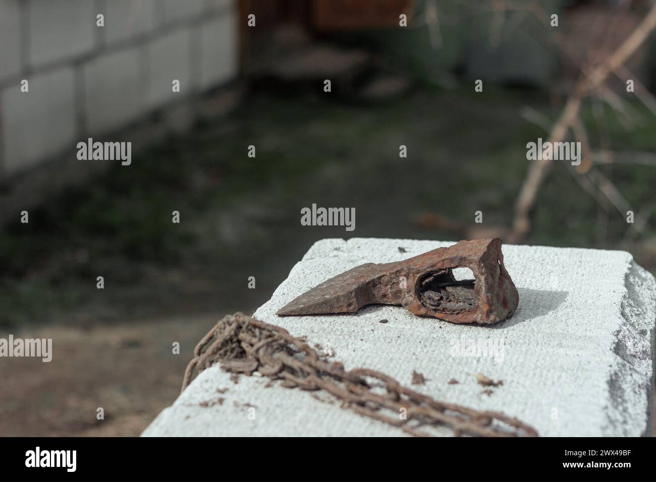 Abstract of Lumberman tools with broken rusted axe, head, chain on a ...