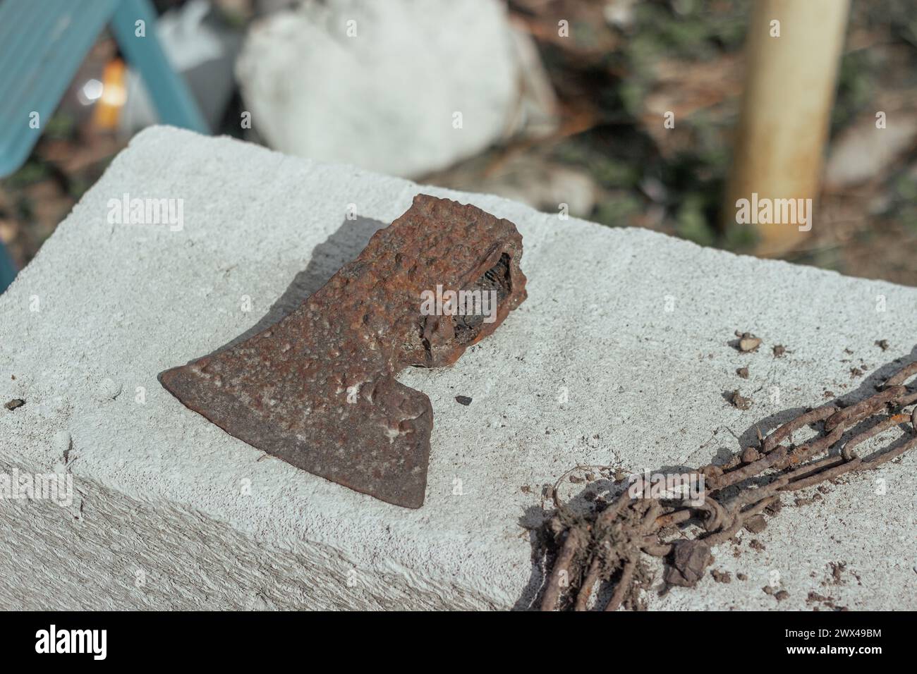 Abstract of Lumberman tools with broken rusted axe, head, chain on a ...