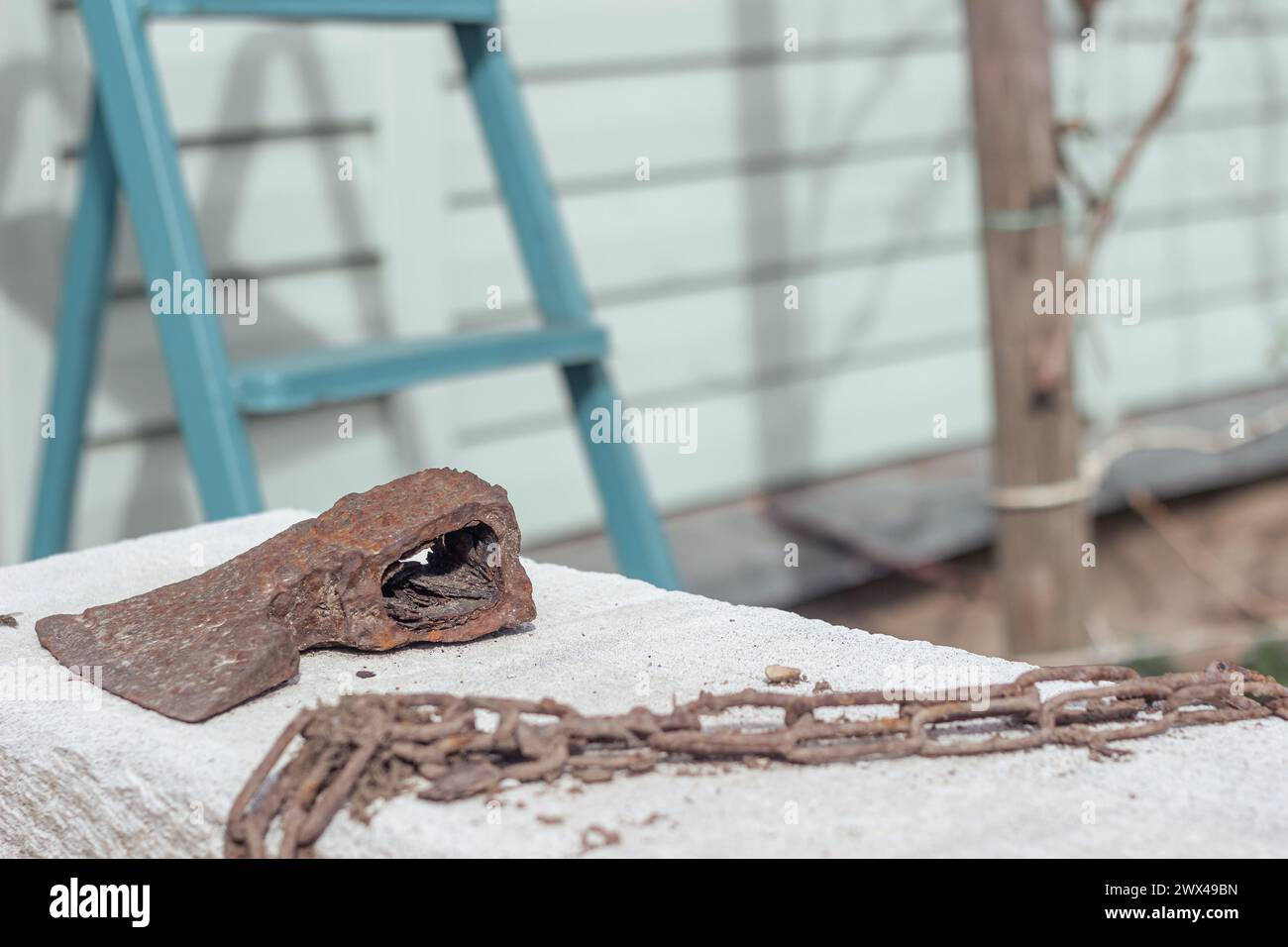 Abstract of Lumberman tools with broken rusted axe, head, chain on a ...
