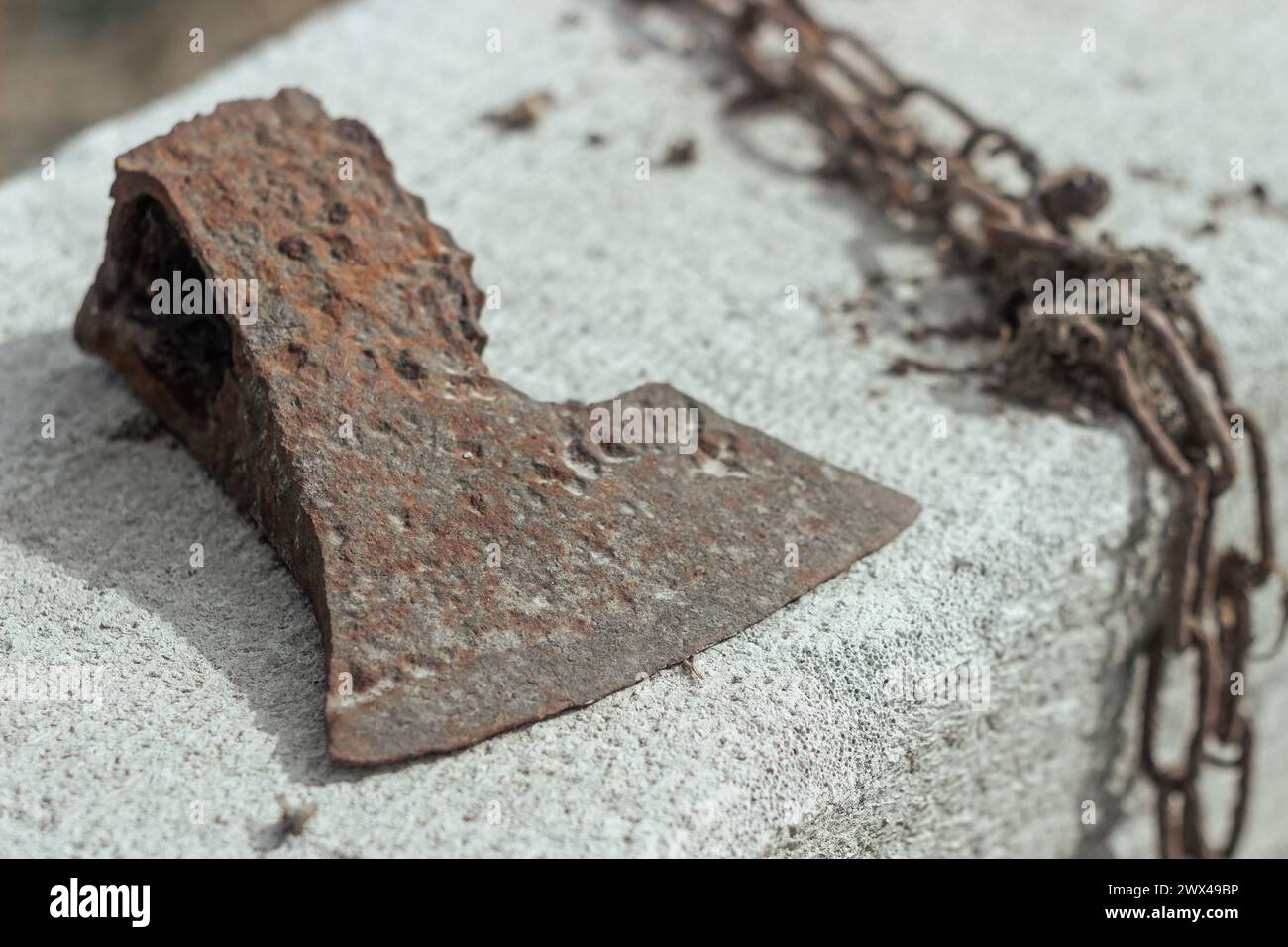 Abstract of Lumberman tools with broken rusted axe, head, chain on a ...