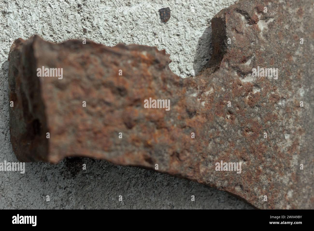 Abstract of Lumberman tools with broken rusted axe, head, chain on a ...