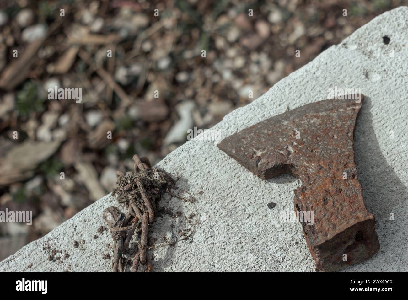 Abstract of Lumberman tools with broken rusted axe, head, chain on a ...