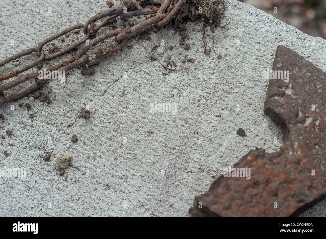Abstract of Lumberman tools with broken rusted axe, head, chain on a ...