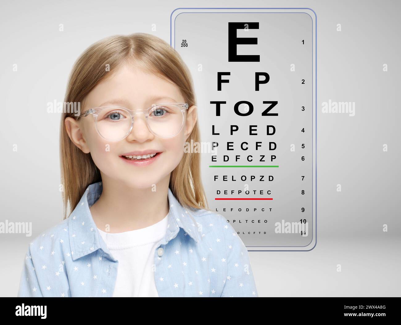 Vision test. Cute little girl in glasses and eye chart on grey ...