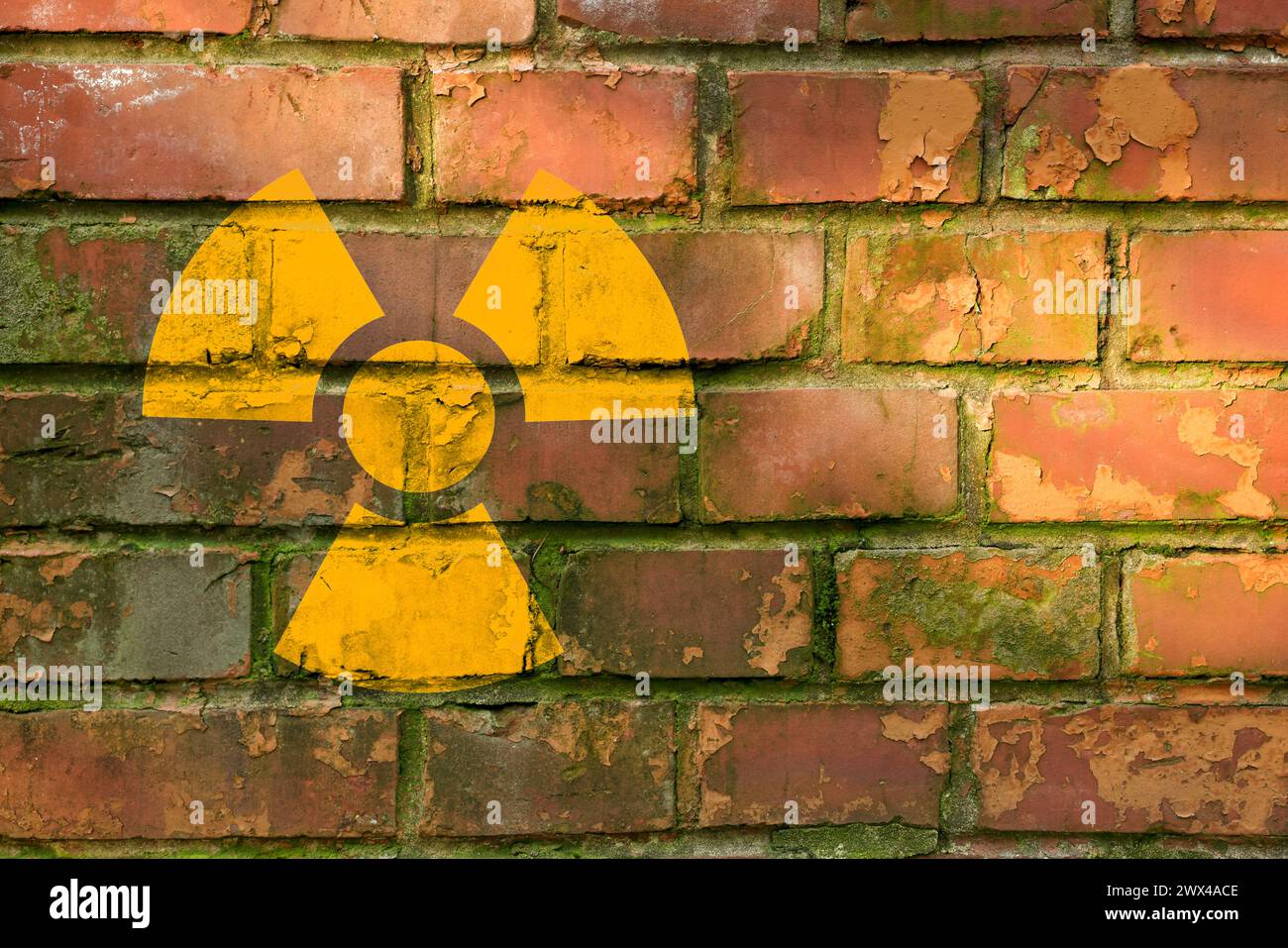 Radioactive sign on brick wall, space for text. Hazard symbol Stock ...