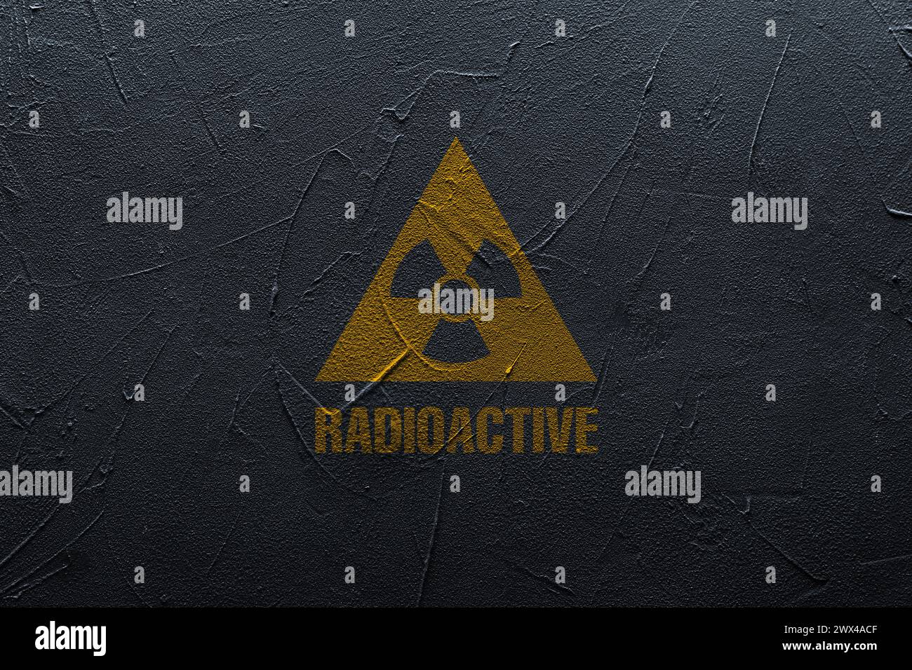 Radioactive sign on black textured wall. Hazard symbol Stock Photo - Alamy