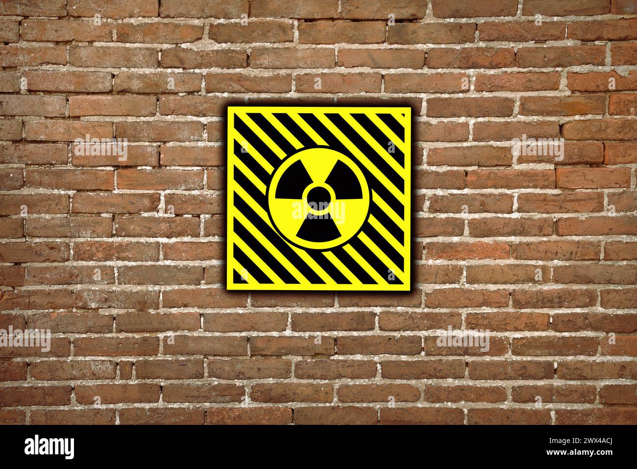 Radioactive sign on brick wall. Hazard symbol Stock Photo - Alamy