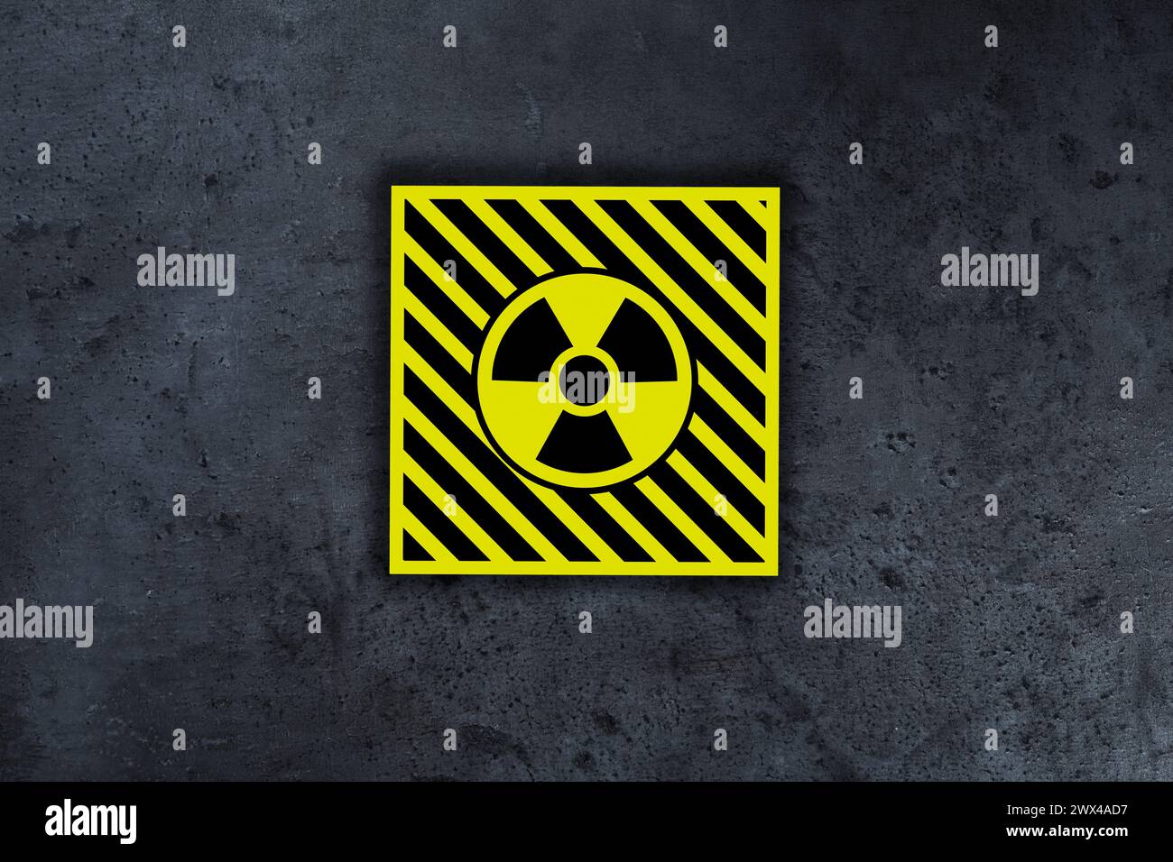 Radioactive sign on grey stone wall. Hazard symbol Stock Photo - Alamy