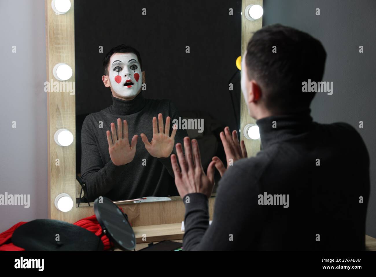 Mime artist posing near mirror in dressing room Stock Photo - Alamy