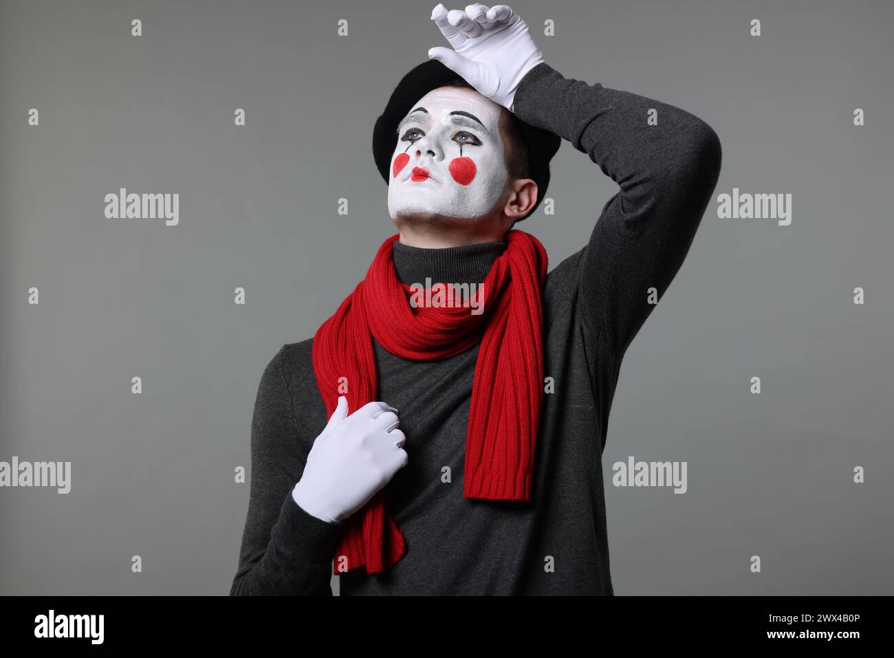 Portrait of mime artist in beret on grey background Stock Photo - Alamy