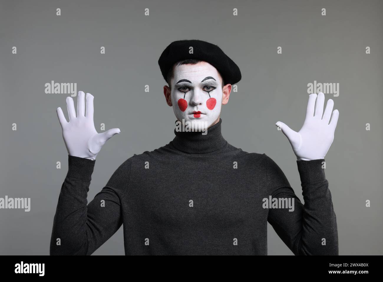 Mime artist in beret posing on grey background Stock Photo - Alamy