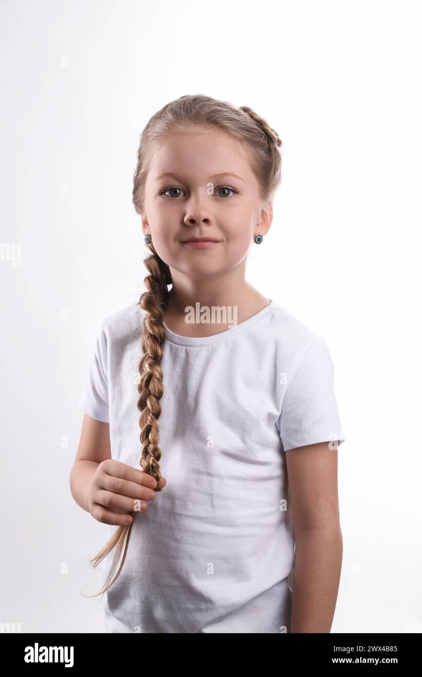 Little girl with braided hair on white background Stock Photo - Alamy