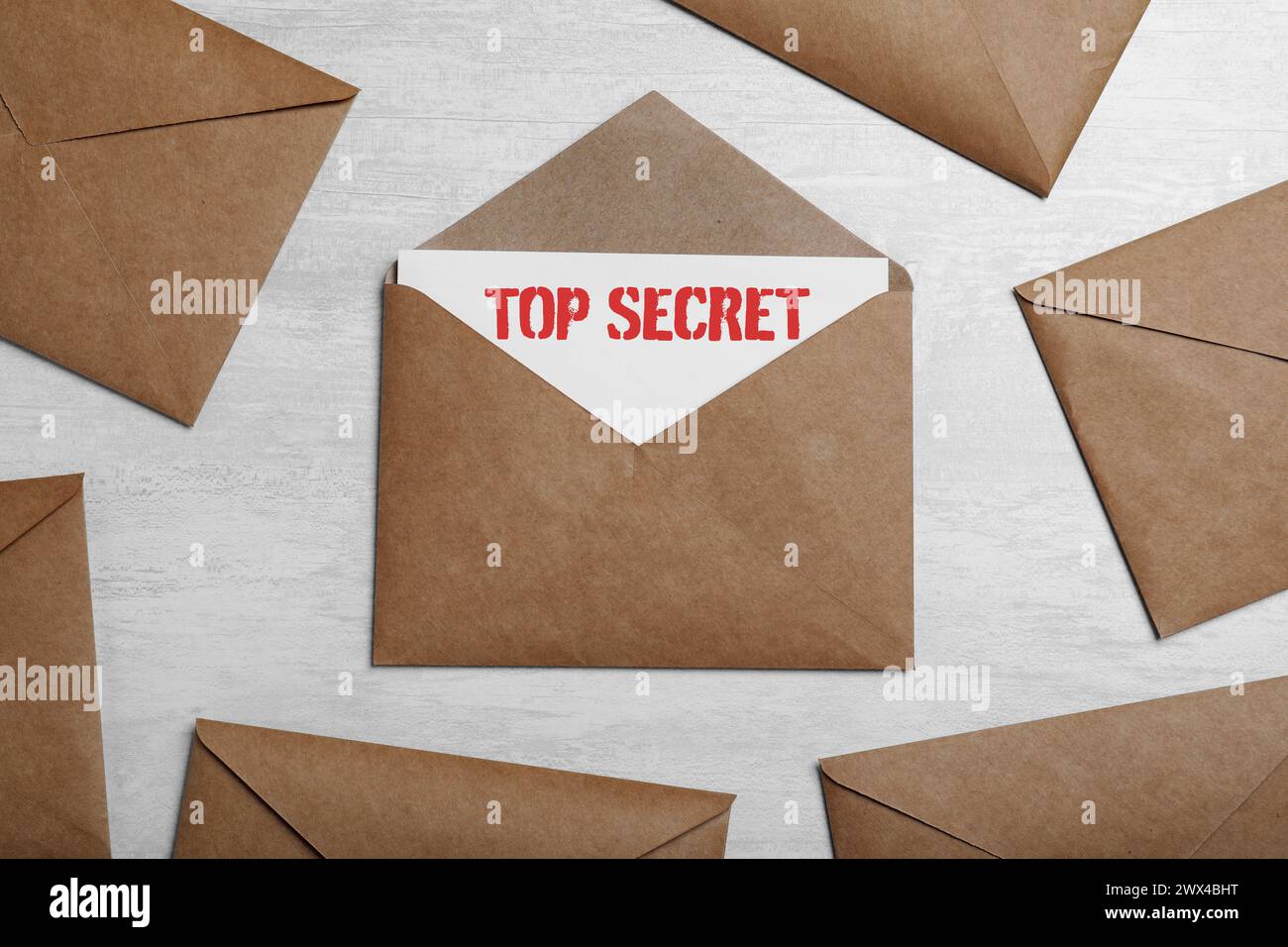 Top Secret stamp. Paper envelopes on light grey table, flat lay Stock ...