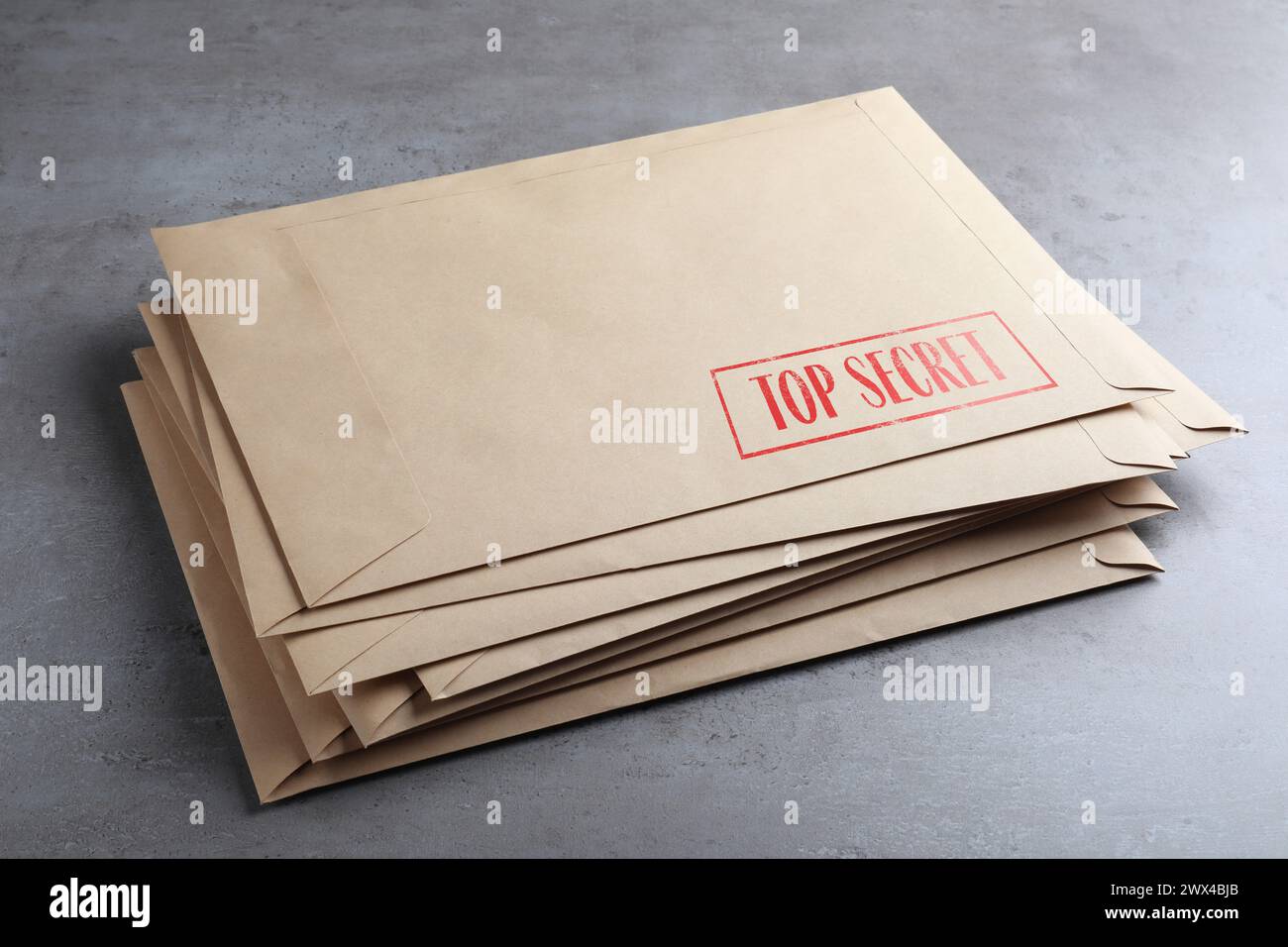 Top Secret stamp. Stacked paper envelopes on grey table Stock Photo - Alamy