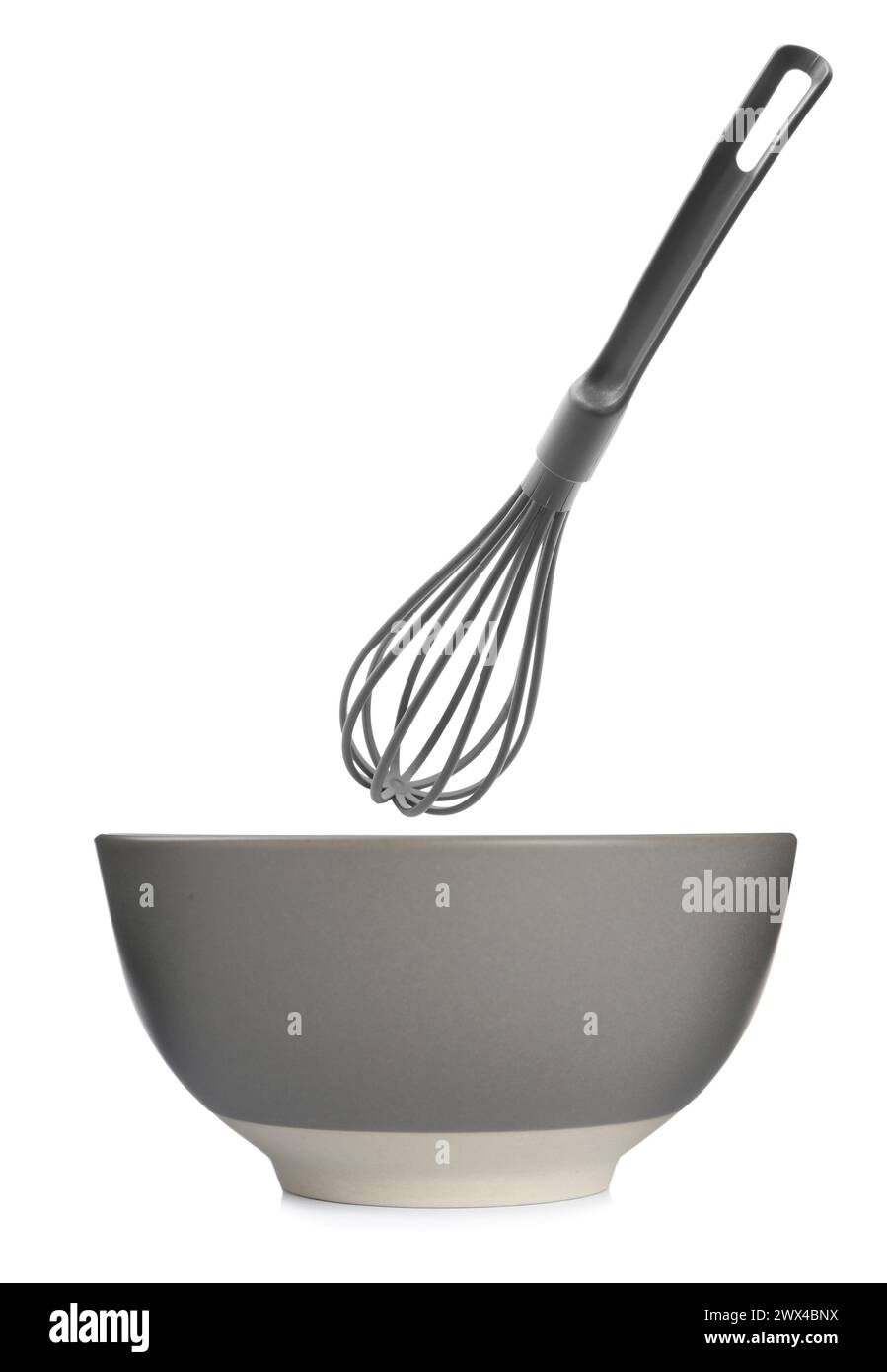 Plastic whisk and ceramic bowl isolated on white. Cooking utensils ...