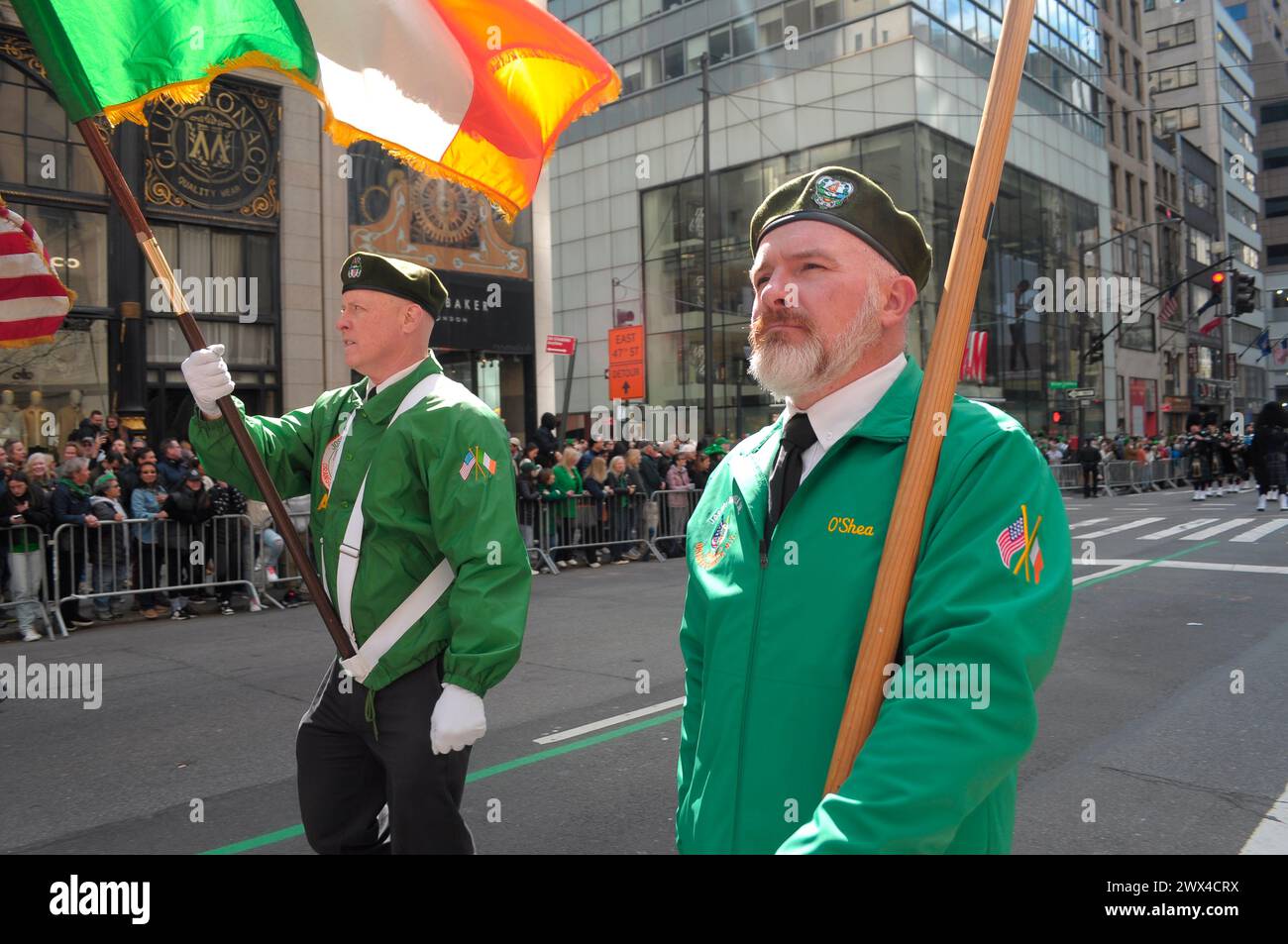Parade participants march while waving an Irish flag at the New York ...