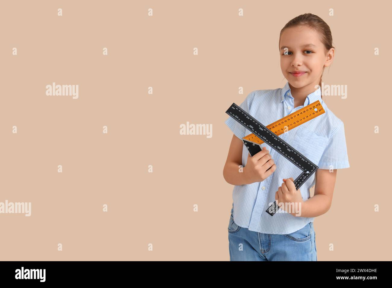 Little architect with rulers on beige background Stock Photo - Alamy