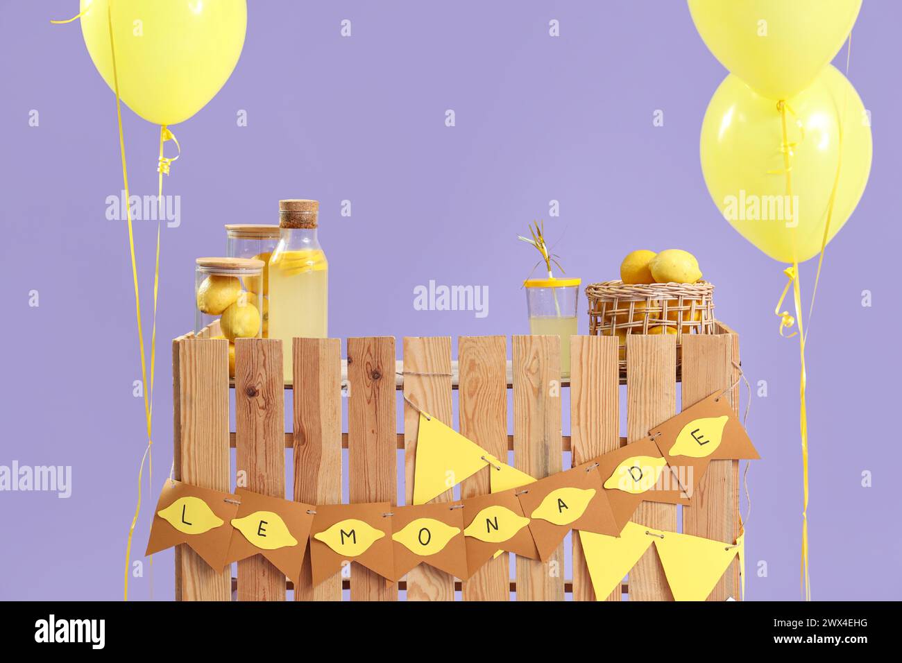 Lemonade stand with balloons on lilac background Stock Photo - Alamy