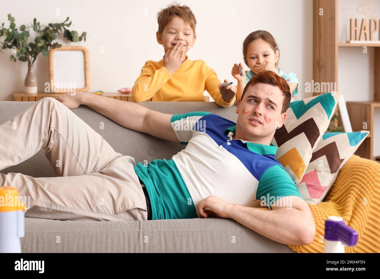 Little kids laughing at their shocked father with paintings on his face ...