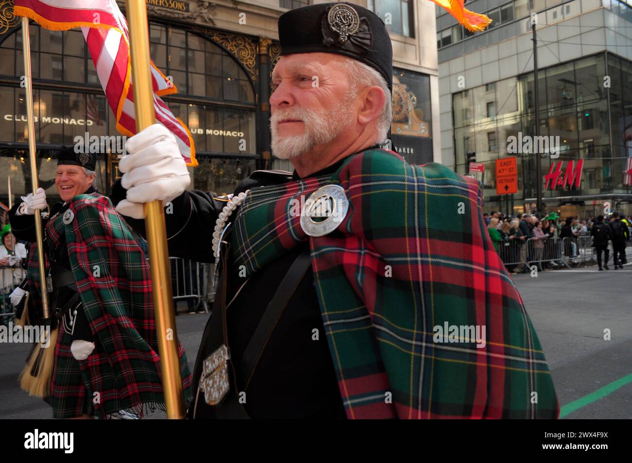 New York, USA. 16th Mar, 2024. Parade participants march while waving ...