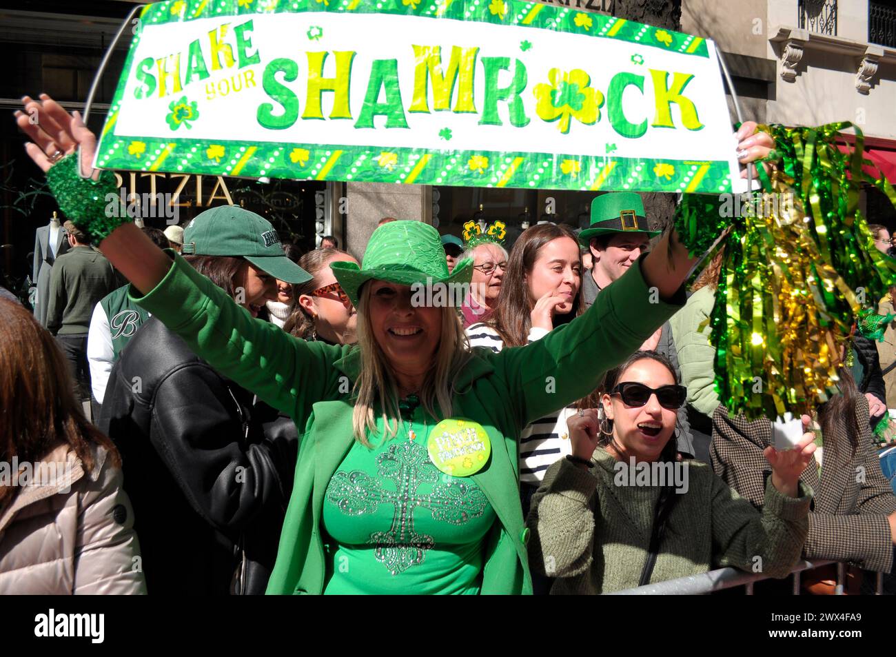 New York, USA. 16th Mar, 2024. A reveler holds up a placard celebrating ...