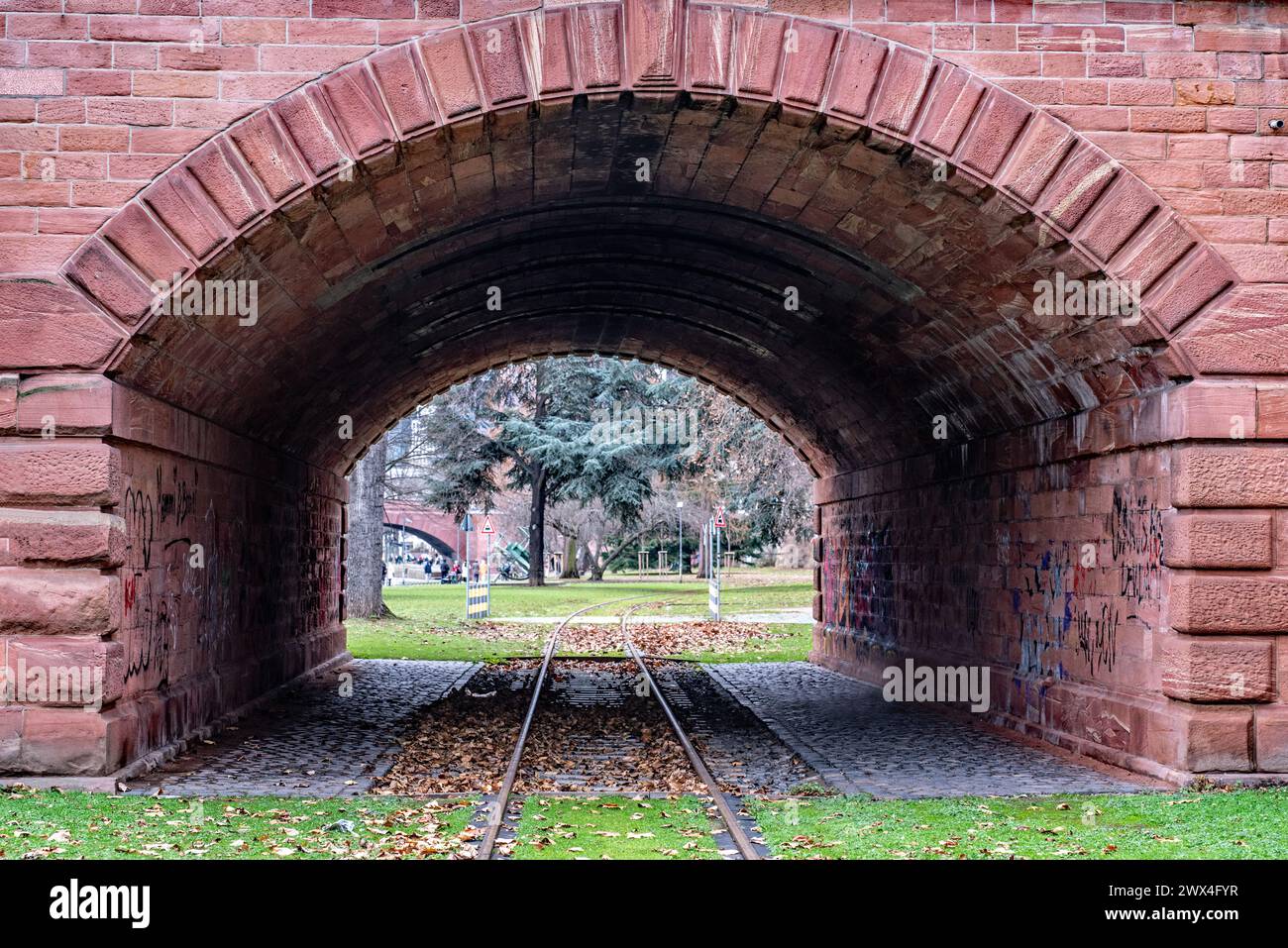 Arches in ancient brick ruins frame a view of empty field Stock Photo ...