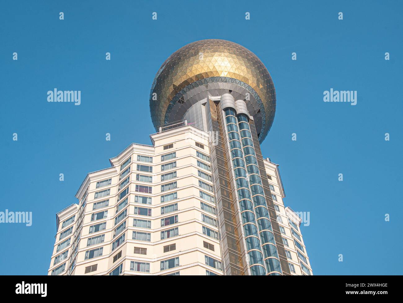 A unique skyscraper with a shiny dome and windows towers high Stock ...