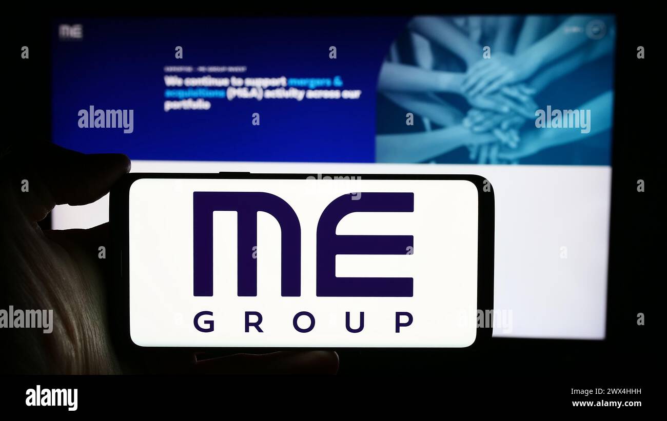 Person holding cellphone with logo of British vending machine company ...