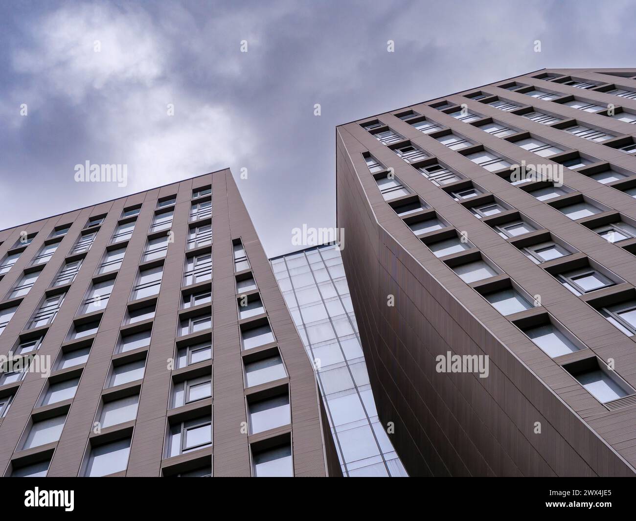Two towering skyscrapers rise into a gloomy sky, showcasing modern ...
