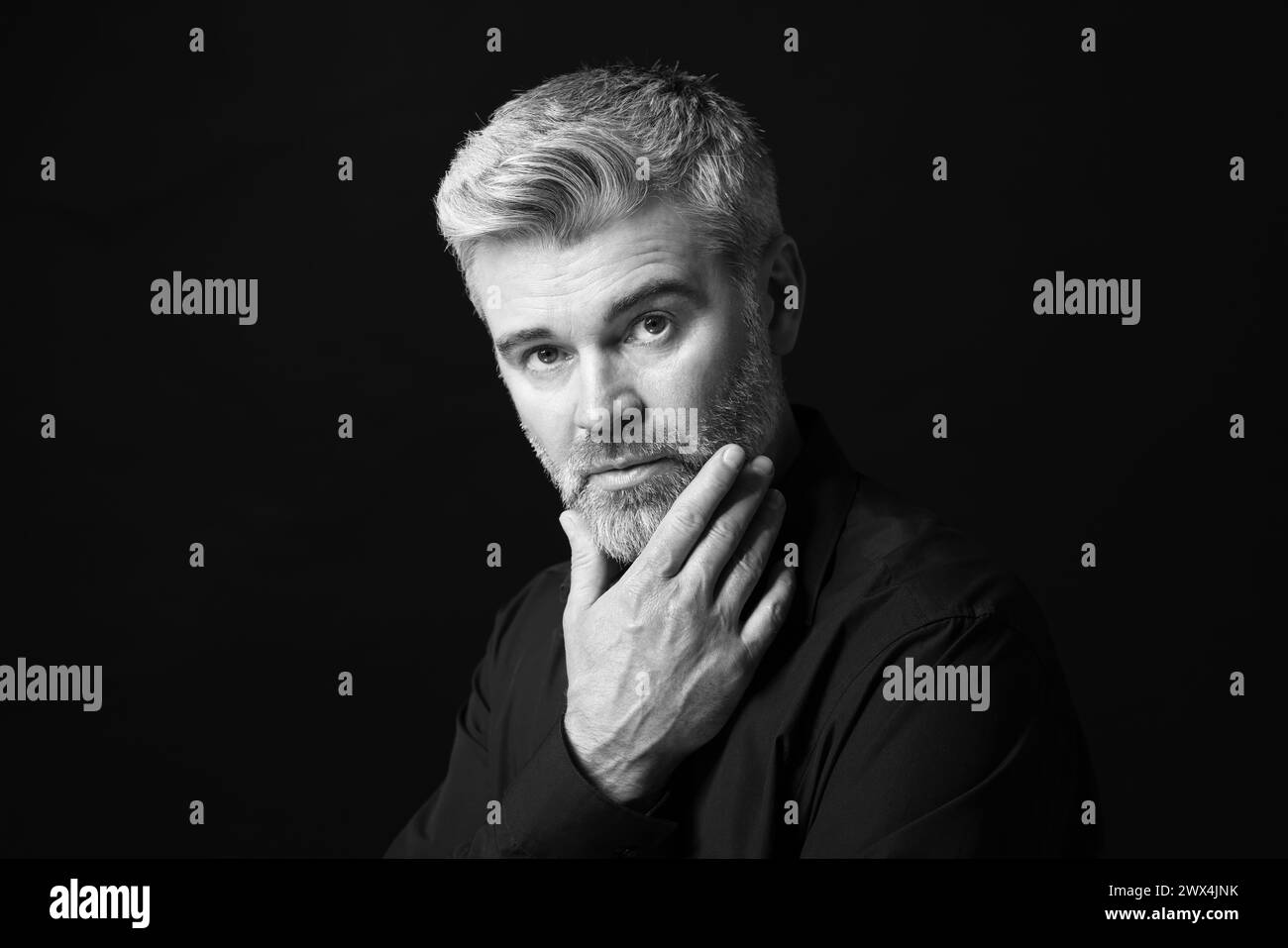 Portrait of handsome man on dark background. Black and white effect ...