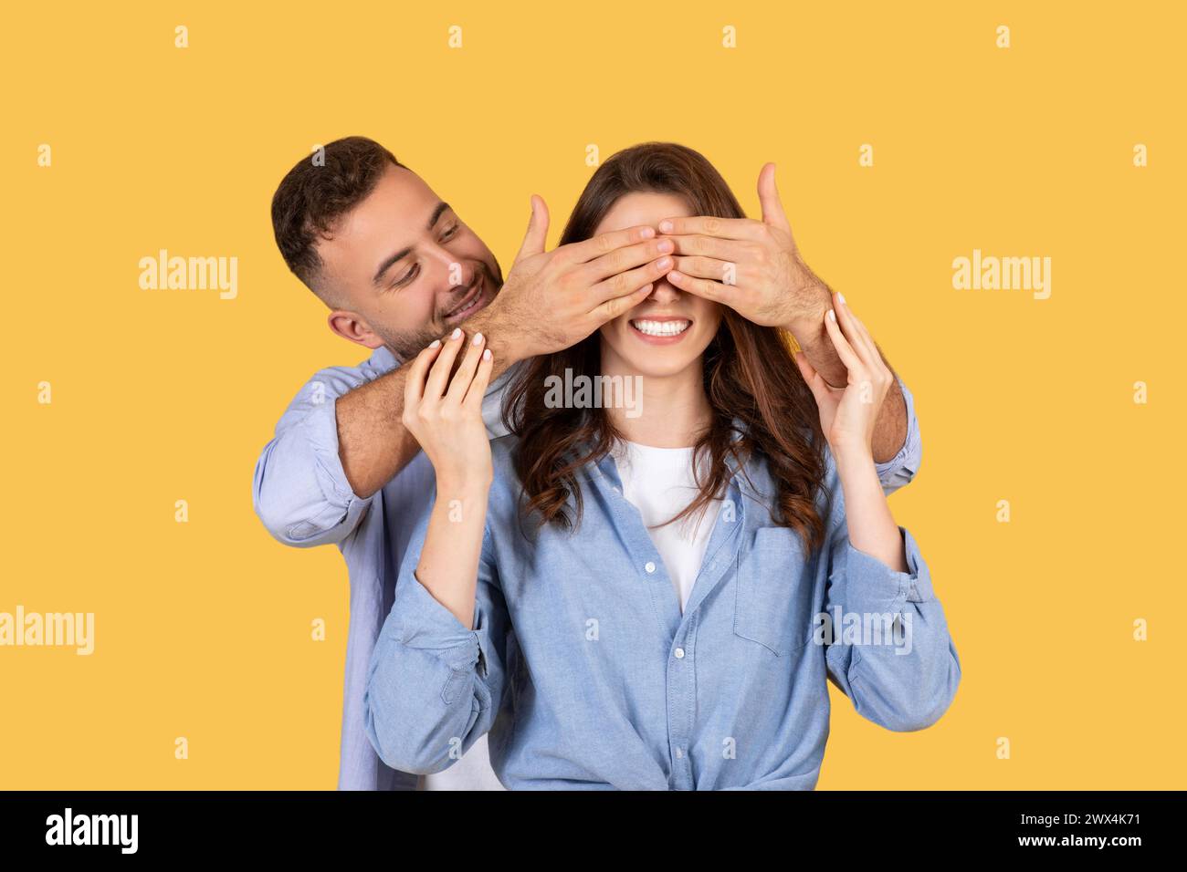 Two people covering each other's eyes Stock Photo - Alamy