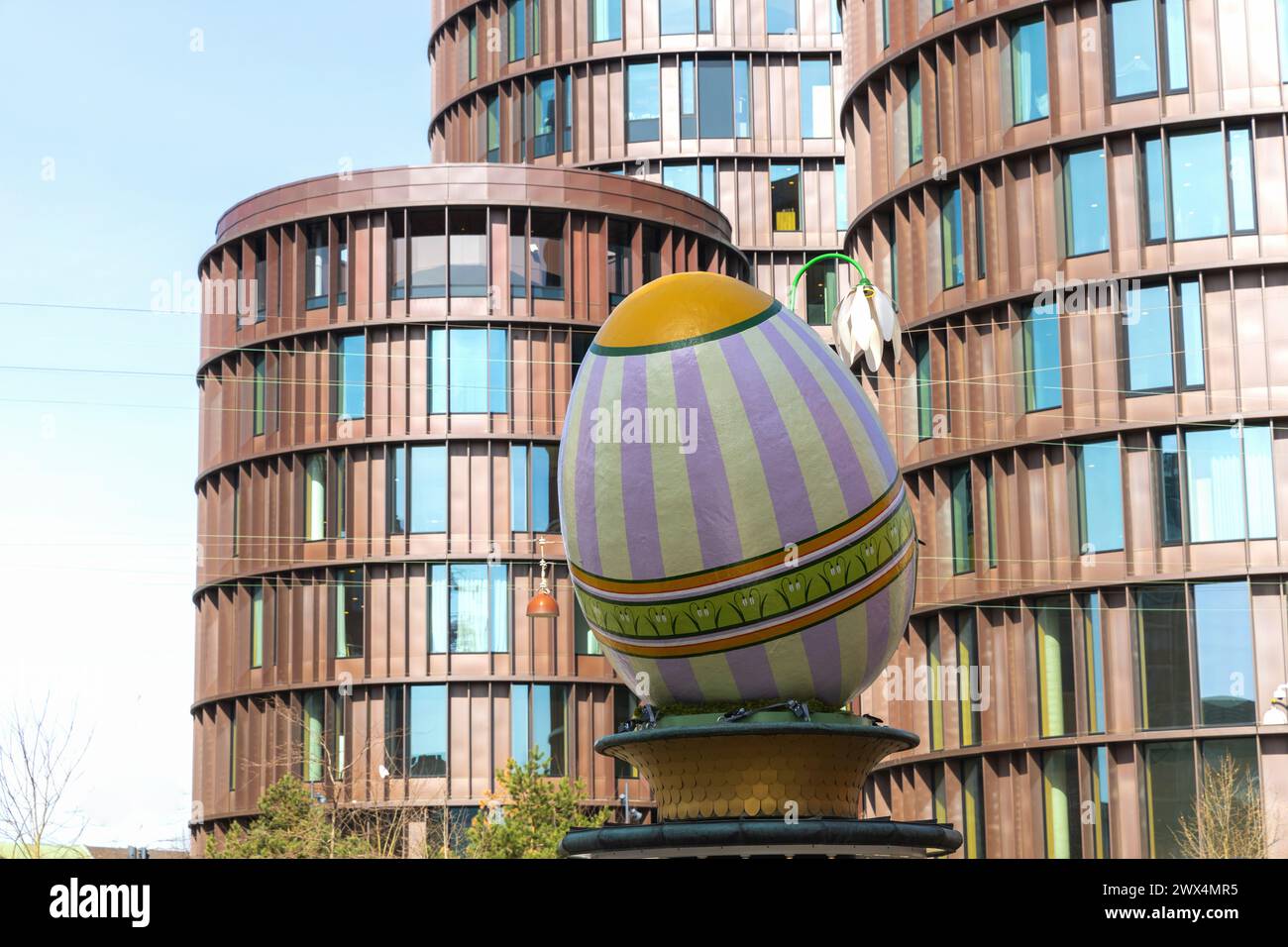 A large decorative Easter egg against a modern building in the city of ...