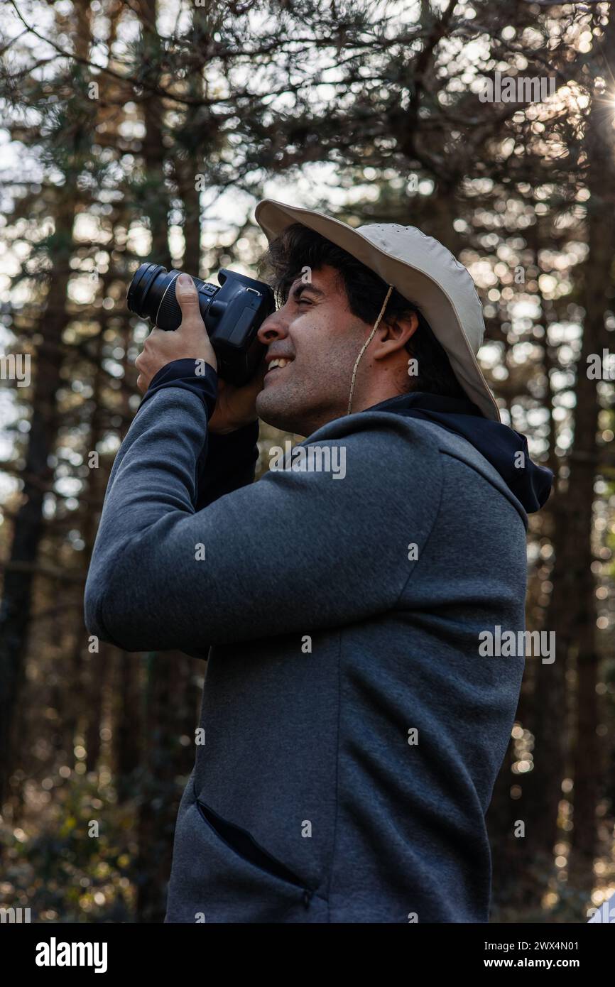 vertical portrait A wilderness photographer, adorned in an explorer's ...