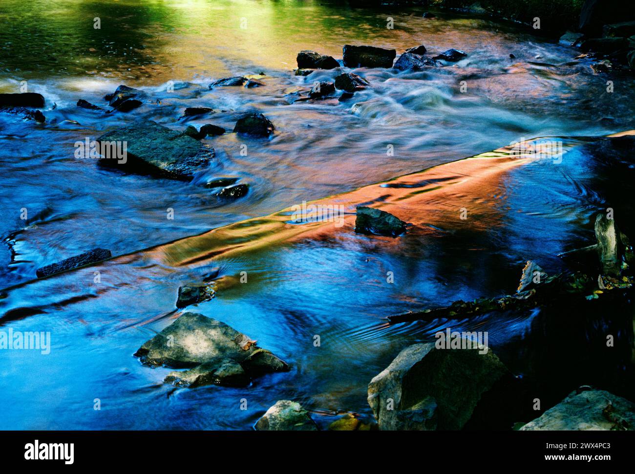 Colorful reflection of the red Pine Valley Covered Bridge in the falls ...