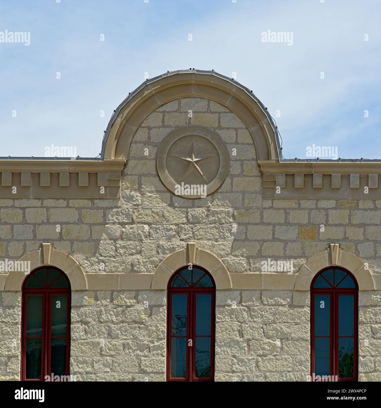 limestone block facade with arched pediment crowned cornice on ...