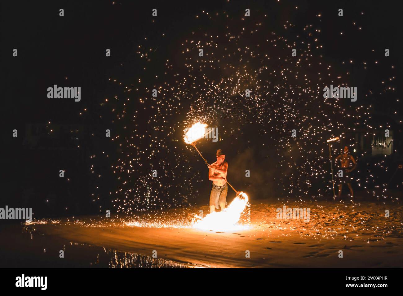 A fire dancer is seen juggles with fire during a fire show, on Koh ...